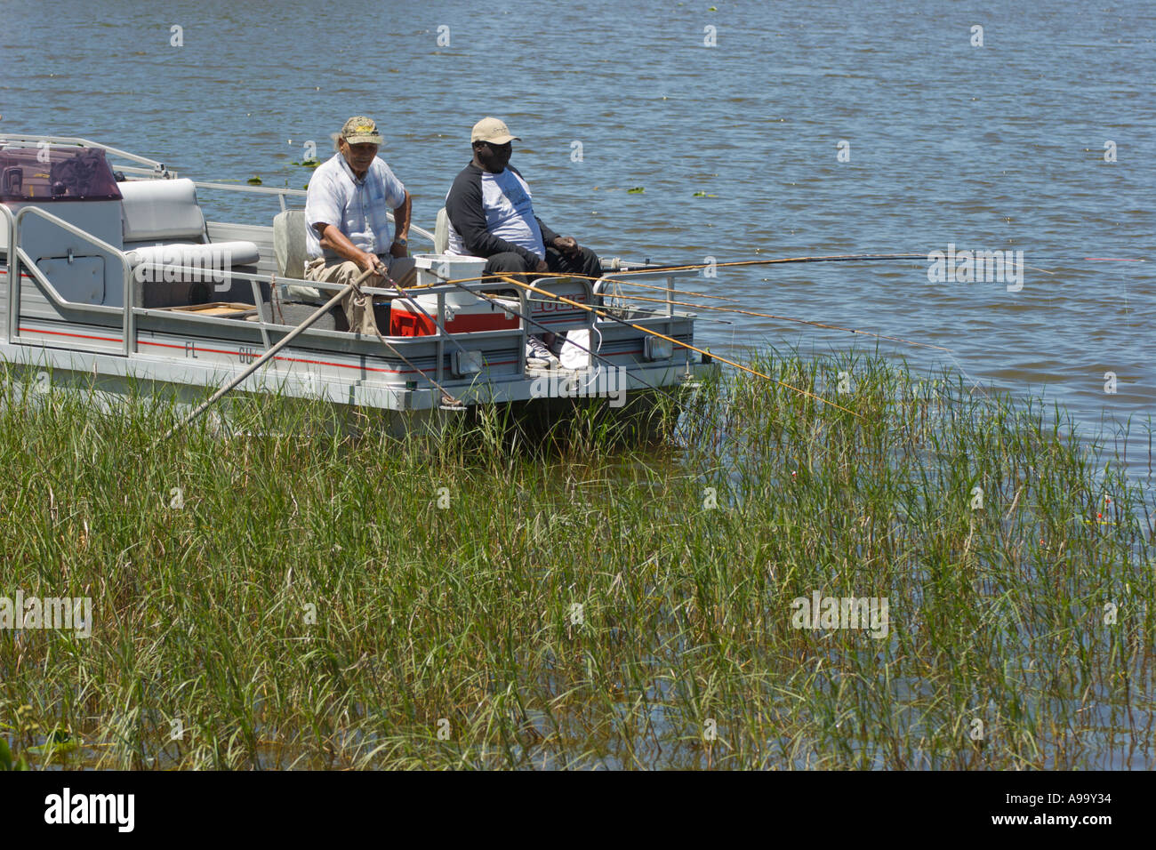 Two black men fishing from boat on Lake Eustis in Central Florida USA ...