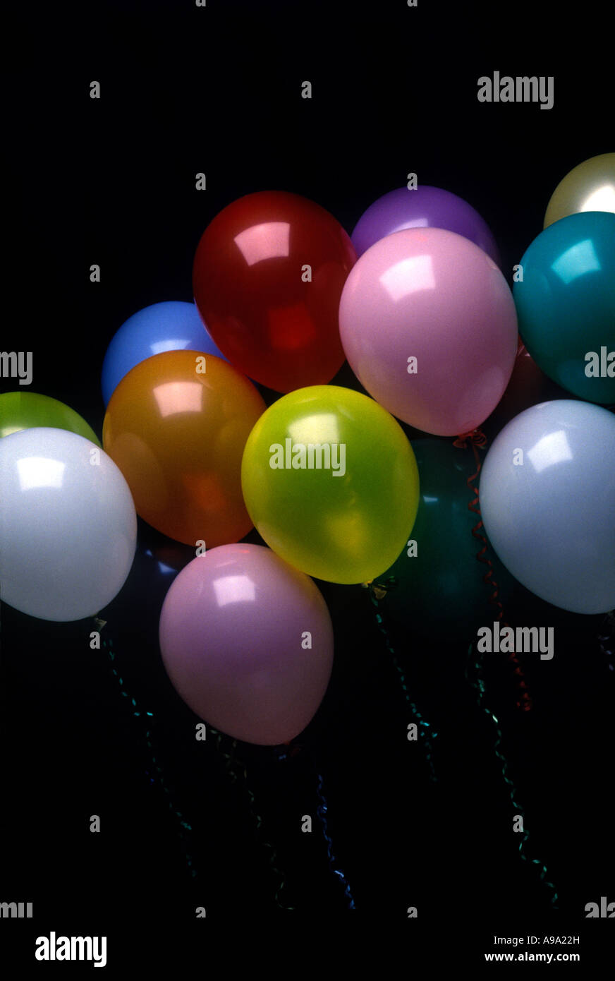 MULTI COLORED GROUP OF BALLOONS ON PLAIN BLACK BACKGROUND Stock Photo ...