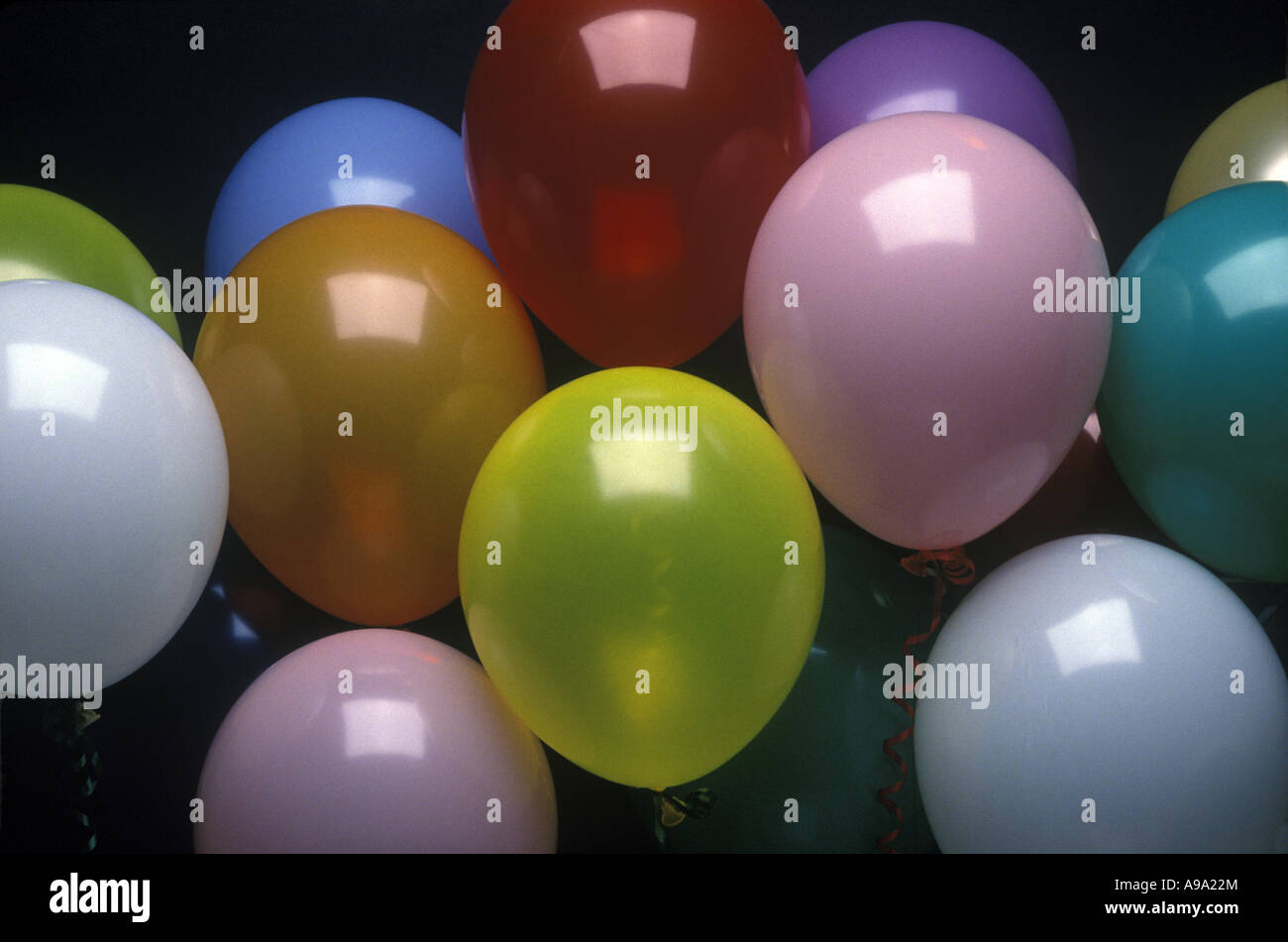 MULTI COLORED GROUP OF BALLOONS ON PLAIN BLACK BACKGROUND Stock Photo ...