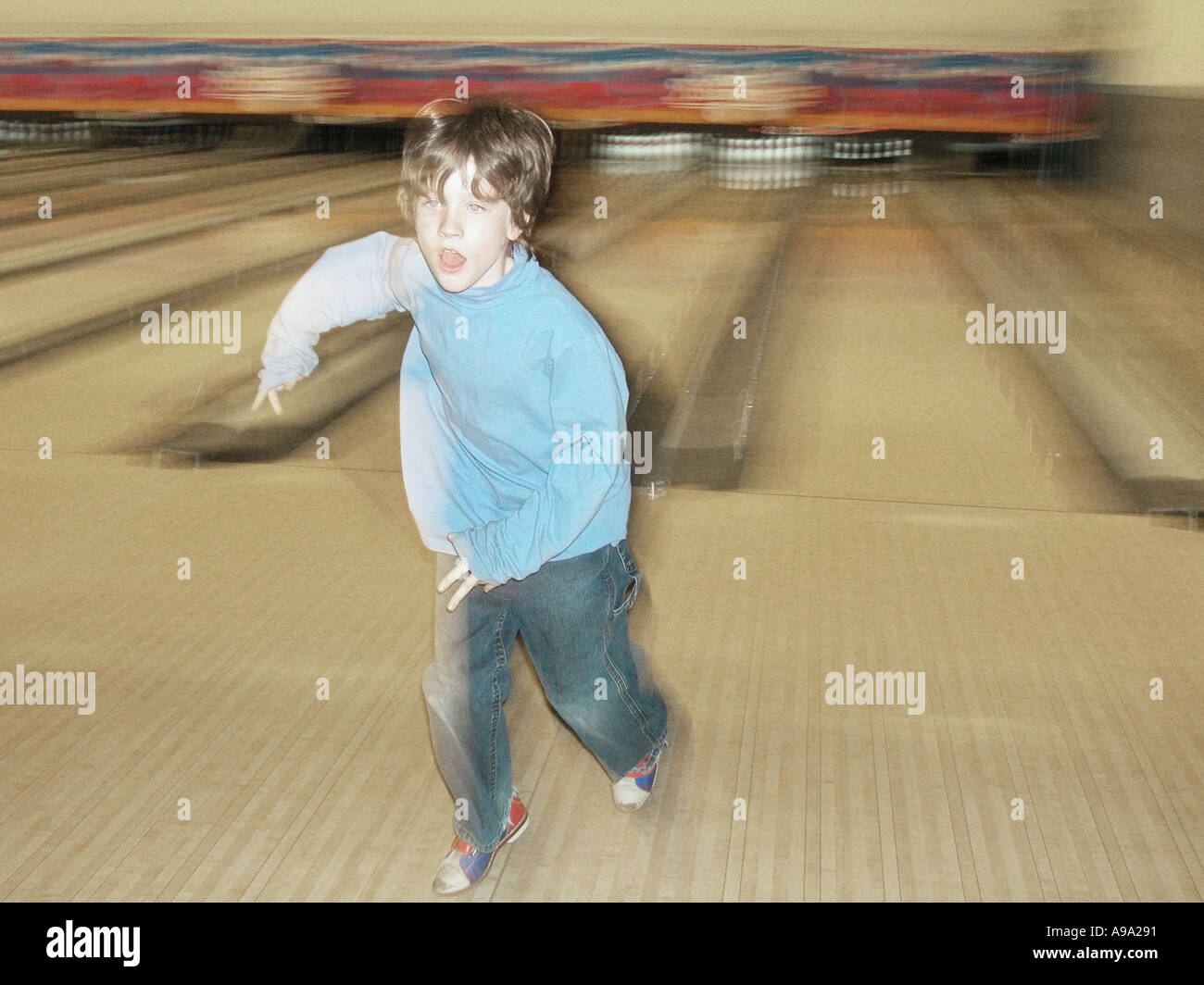 Ten year old boy bowling Stock Photo - Alamy