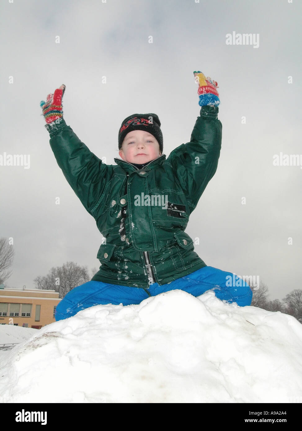 Five year old boy playing king of the hill in the snow Stock Photo - Alamy