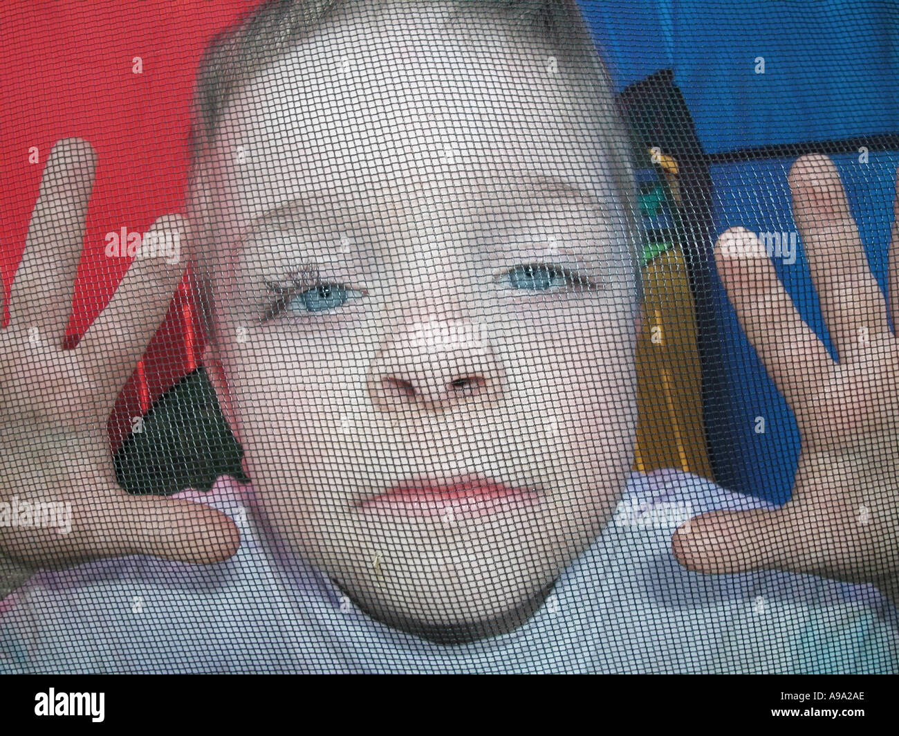 Five year old boy playing behind mesh screen close up portrait Stock ...