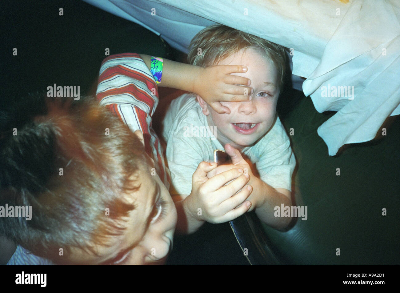 Children playing at a family dinner in a restaurant Stock Photo - Alamy