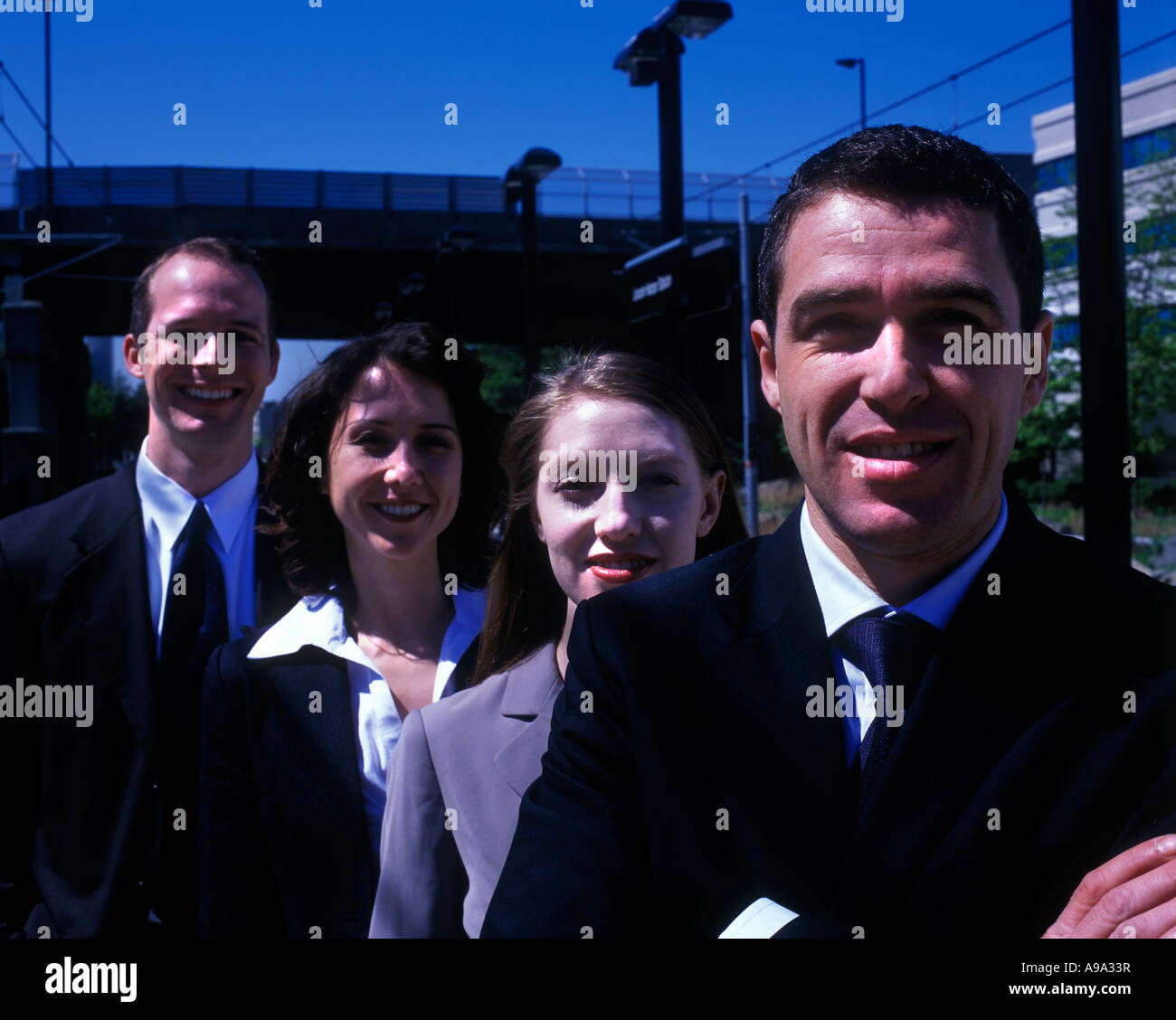 GROUP OF YOUNG OFFICE WORKERS ON LIGHT RAILWAY STATION PLATFORM Stock ...