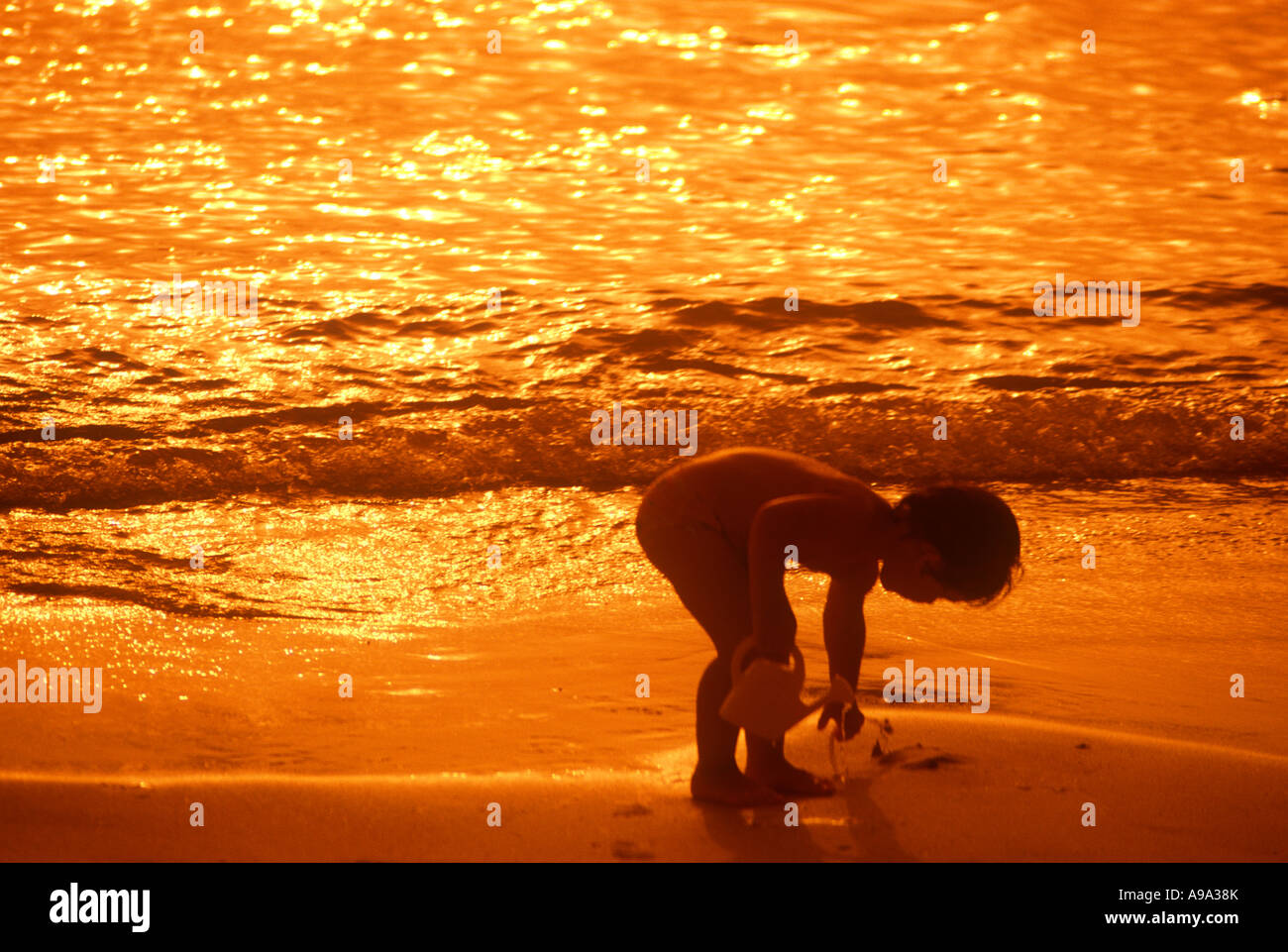 Bending down to pick up hi-res stock photography and images - Alamy