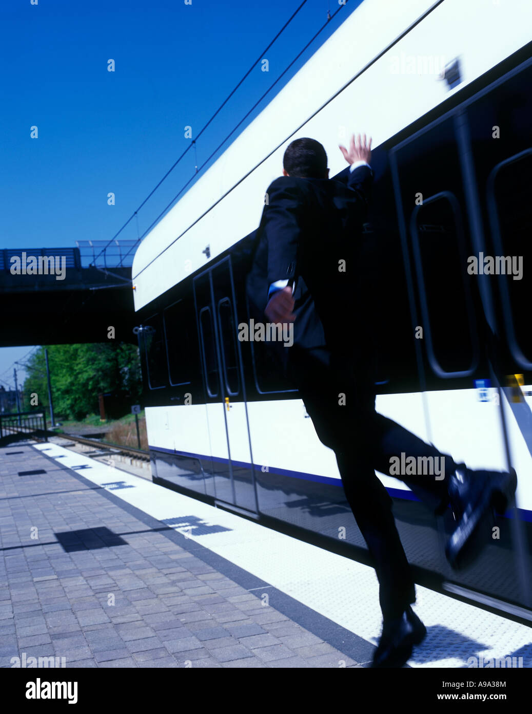 BUSINESSMAN RUNNING LATE MISSING TRAIN Stock Photo - Alamy