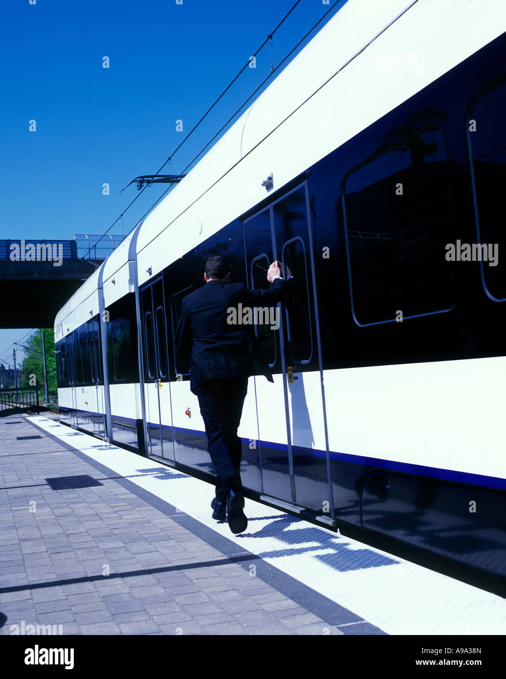 BUSINESSMAN RUNNING LATE MISSING TRAIN Stock Photo - Alamy