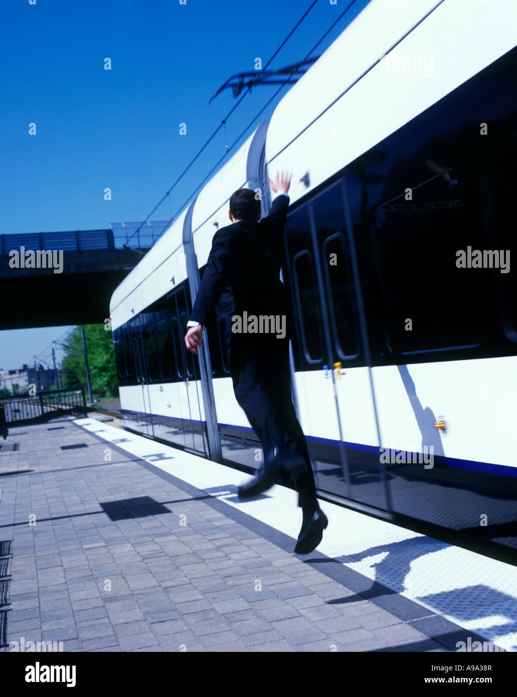 BUSINESSMAN RUNNING LATE MISSING TRAIN Stock Photo - Alamy
