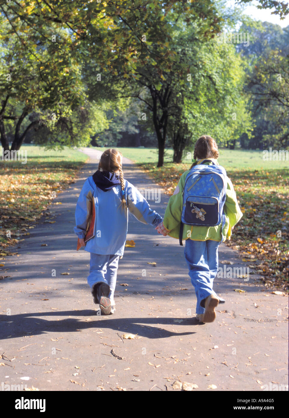 Two girls walking to school Stock Photo - Alamy