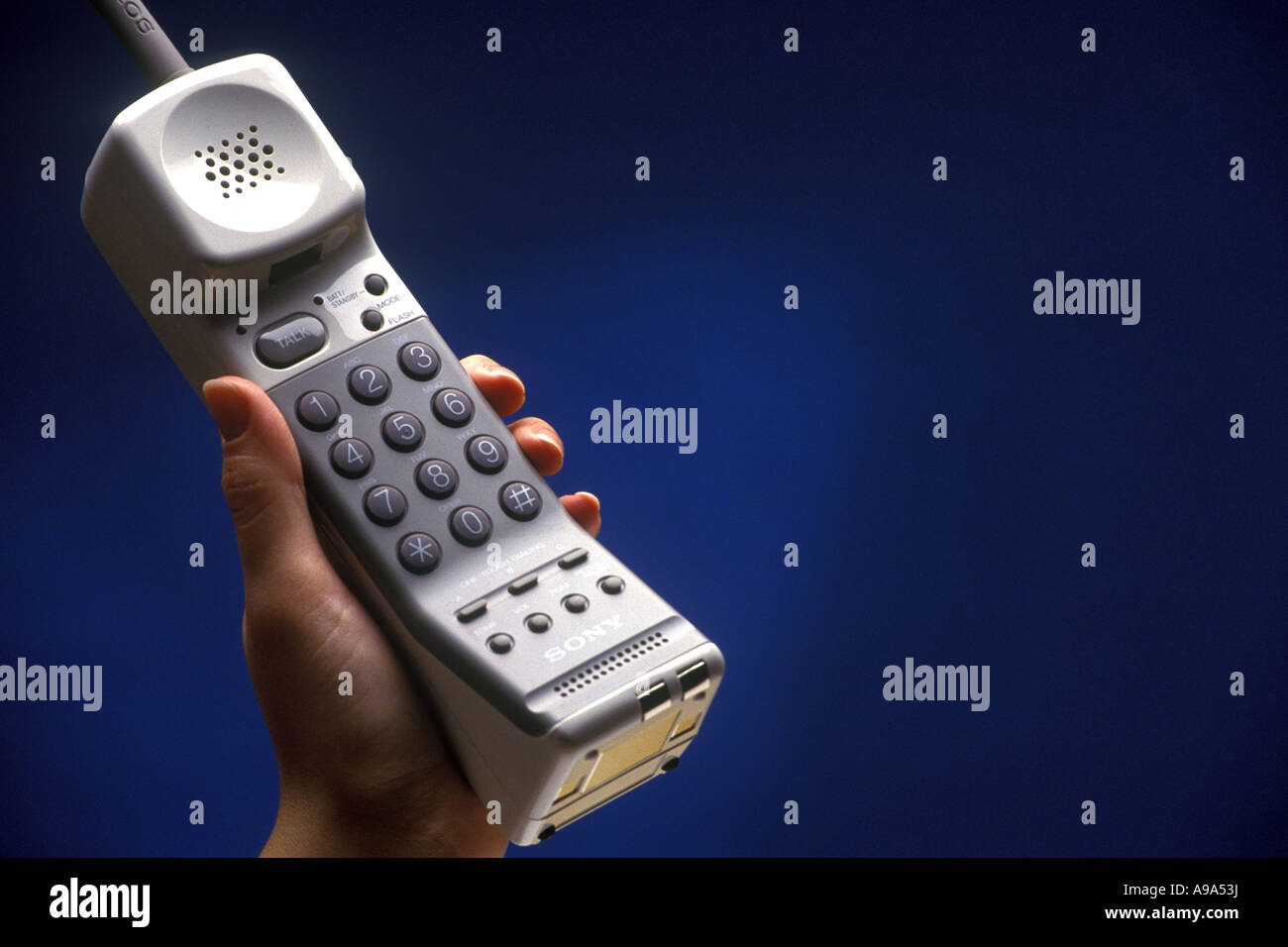 WOMAN'S HAND HOLDING UP TELEPHONE Stock Photo - Alamy