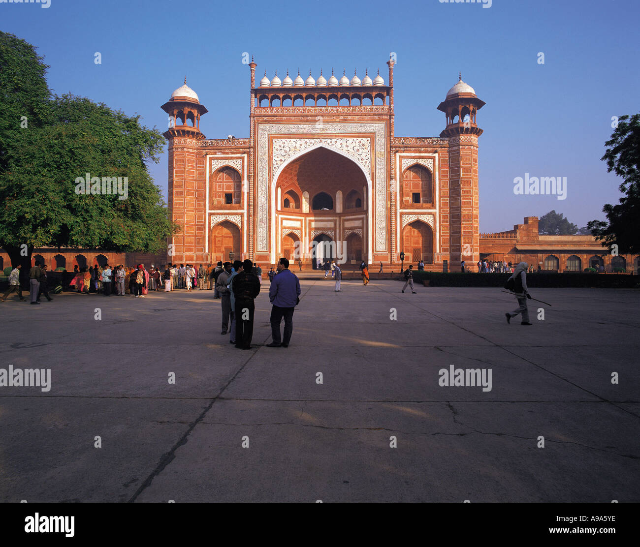 Entrance gate to the Taj Mahal some early morning visitors waiting to ...