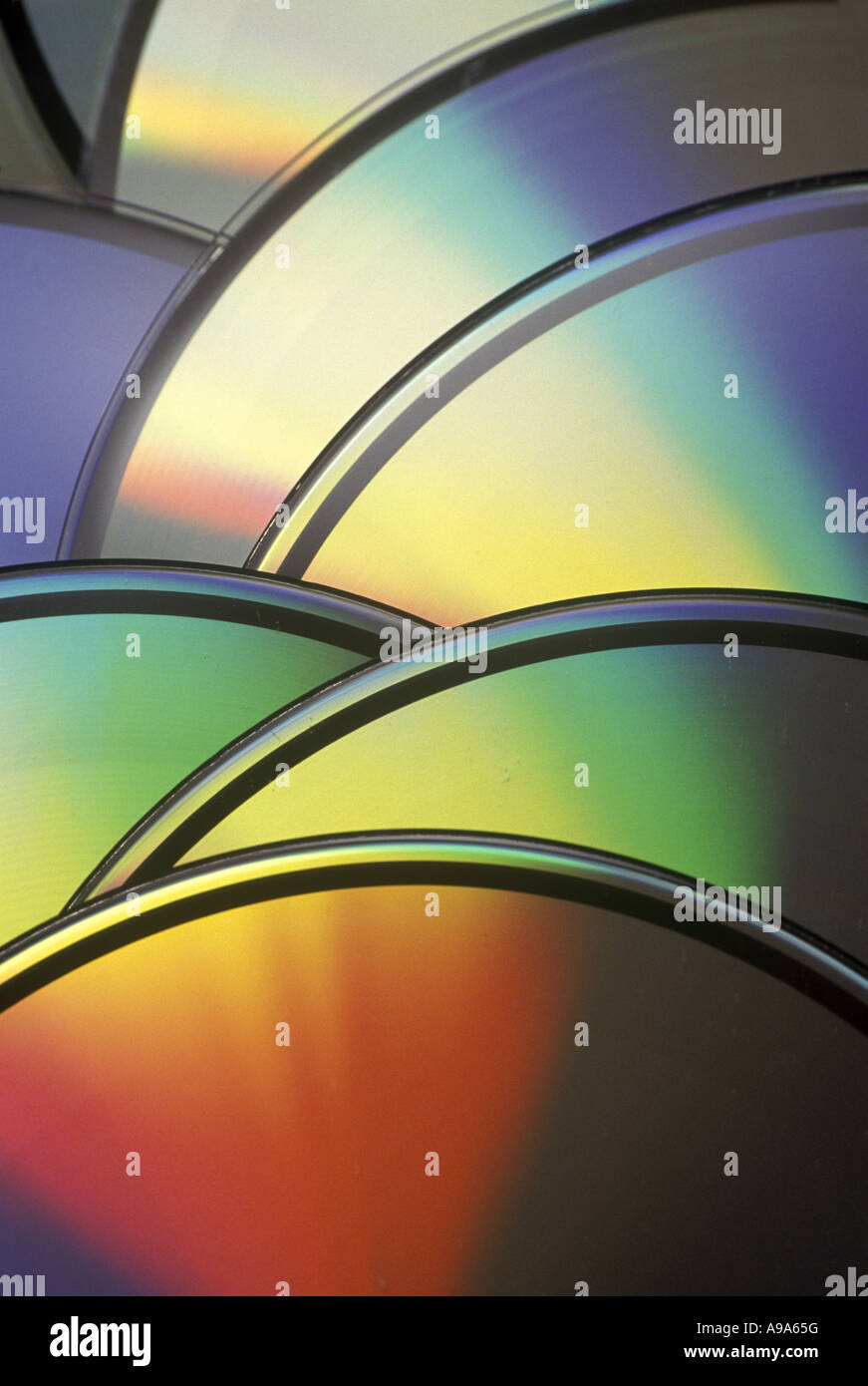 RAINBOW POLARISED COLORS REFLECTED OFF PILE OF CD ROM COMPACT DISCS ...
