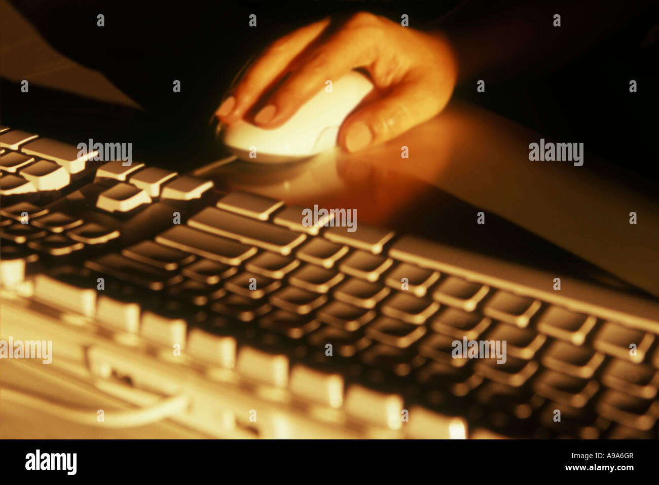 WOMANS HAND HOLDING COMPUTER MOUSE AND KEYBOARD ON DESK Stock Photo - Alamy