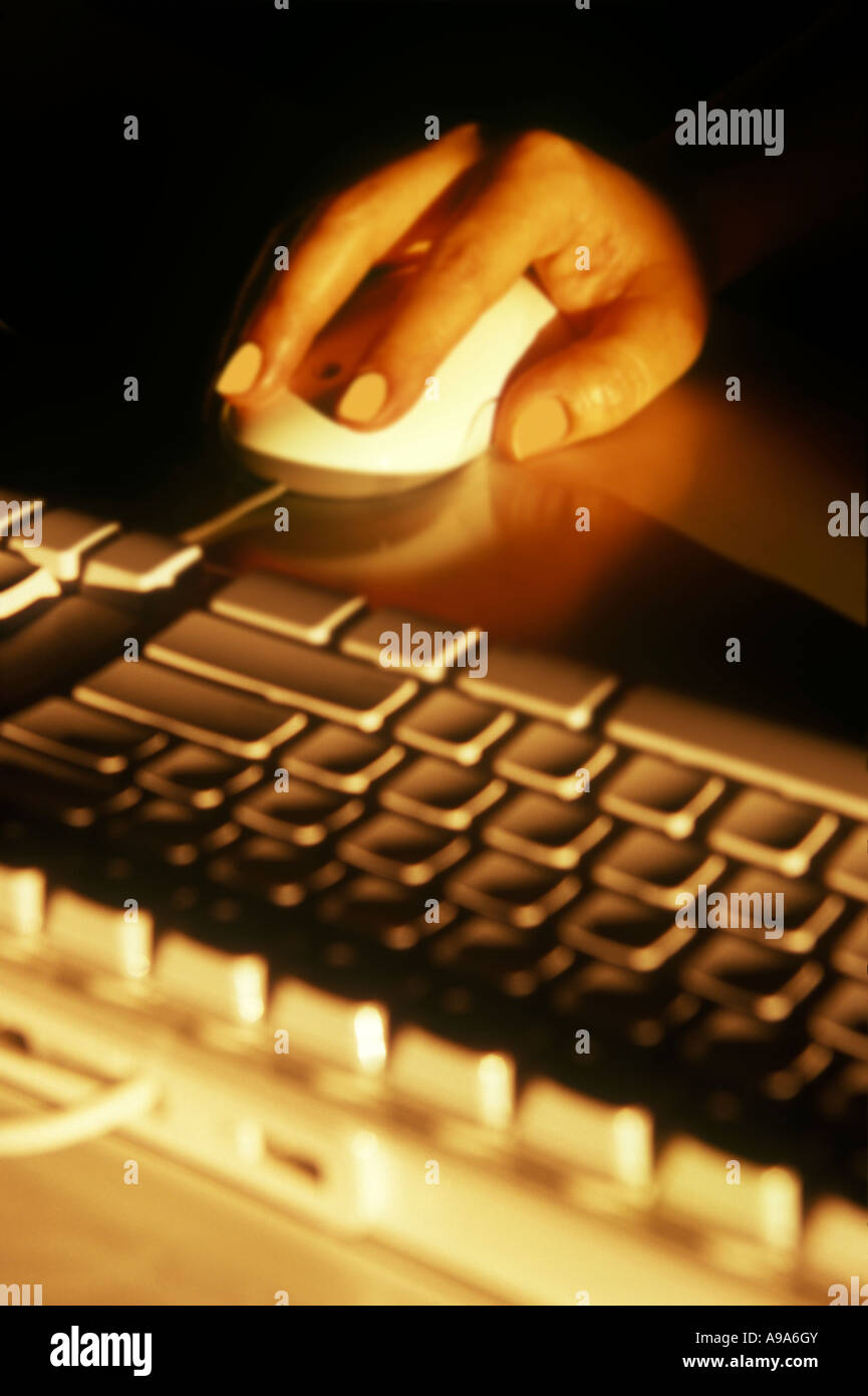 WOMANS HAND HOLDING COMPUTER MOUSE AND KEYBOARD ON DESK Stock Photo - Alamy