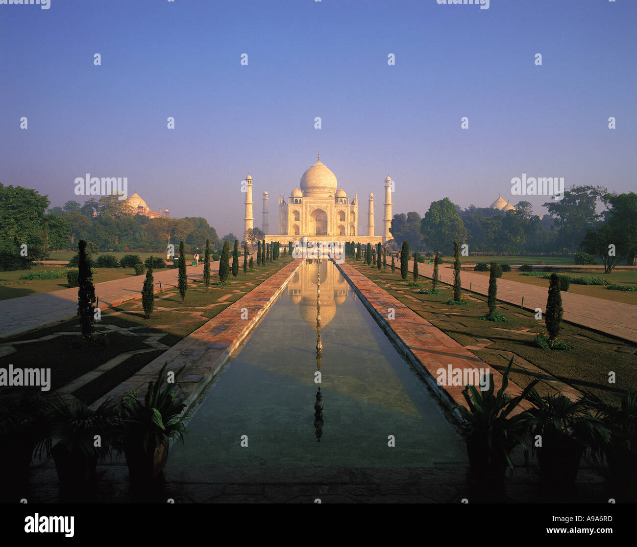 Classic early morning view of the Taj Mahal reflecting in still water ...