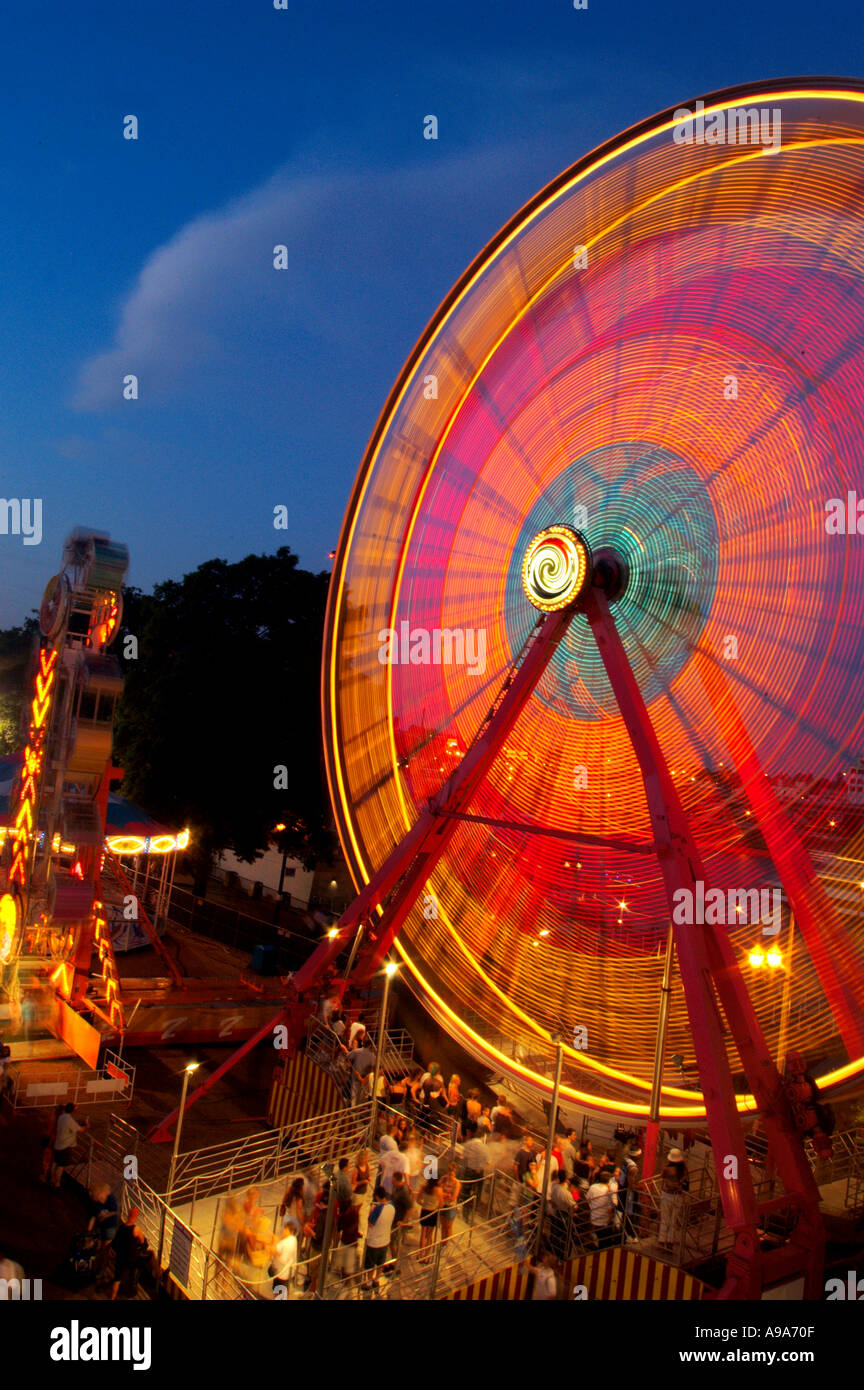 ferris wheel carnival night sky colorful amusement park games crowds ...