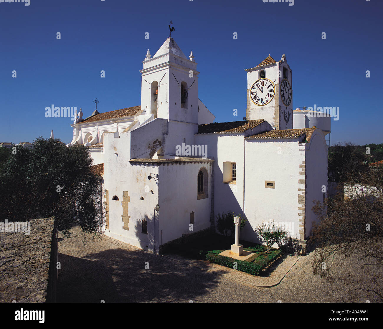 Very traditional stone built church with twin square towers in the town ...