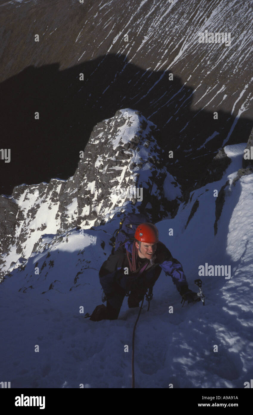 Climber approaching the summit of Ben Nevis via Tower Ridge in winter ...