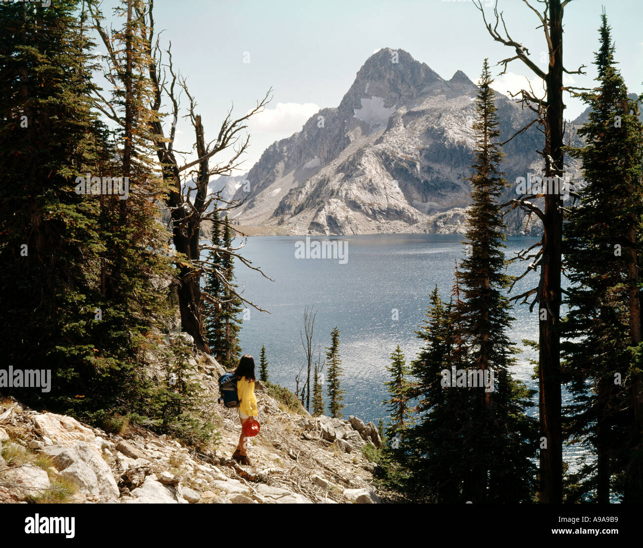 Hiker enjoys the view of Sawtooth Lake and Mount Regan after a four ...