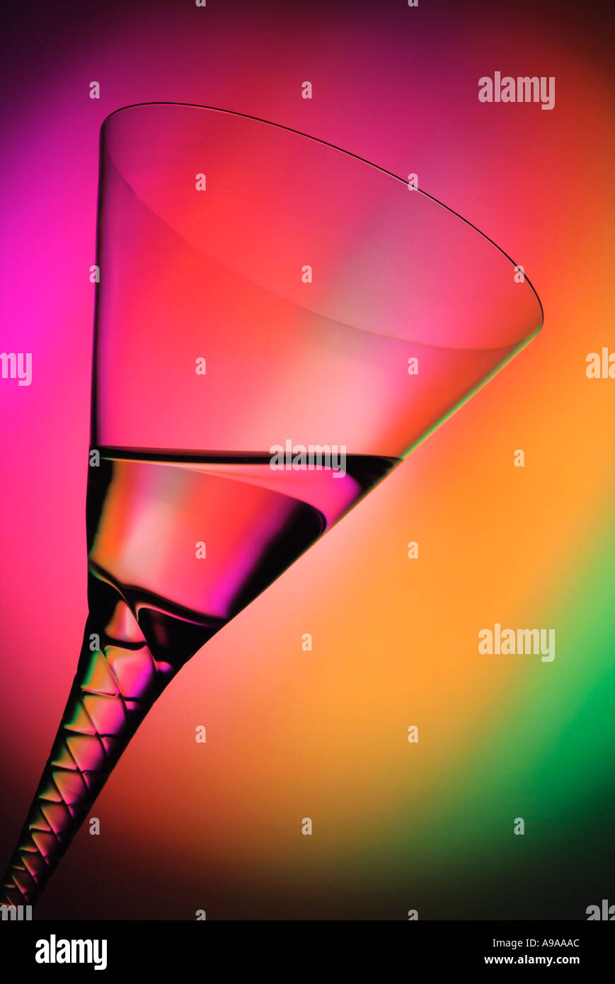 Cocktail glass against a colorful background Stock Photo - Alamy