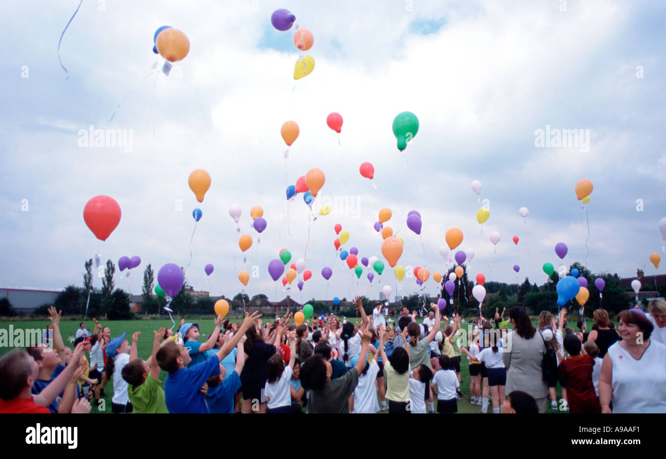 Primary School children release helium balloons into sky Stock Photo ...