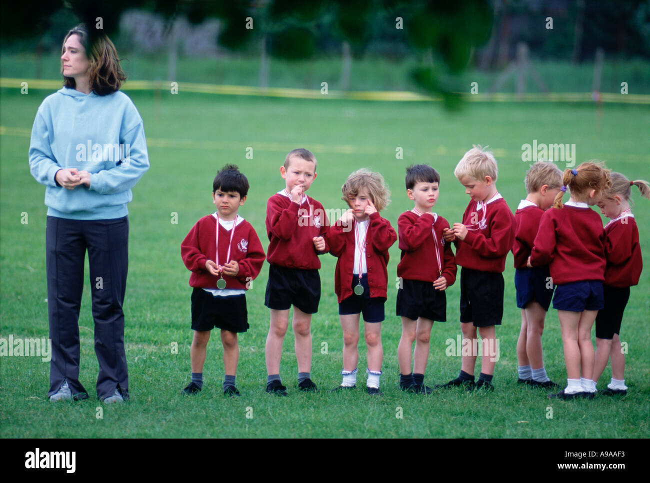 Group of five year old primary school students line up with teacher nr ...