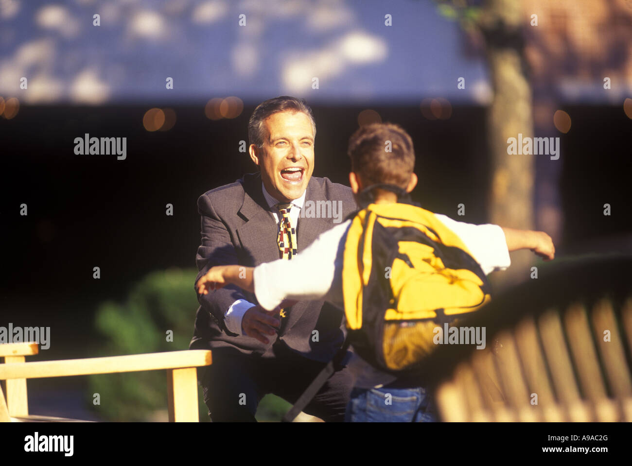 YOUNG BOY RUNS TO FATHER WITH OPEN ARMS Stock Photo - Alamy