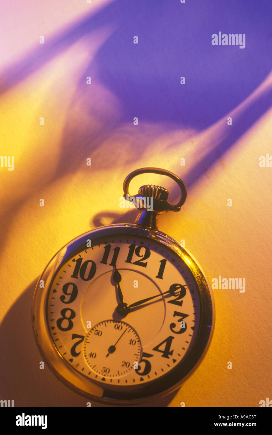 POCKET WATCH AND SILHOUETTE OF HOURGLASS SAND TIMER Stock Photo - Alamy