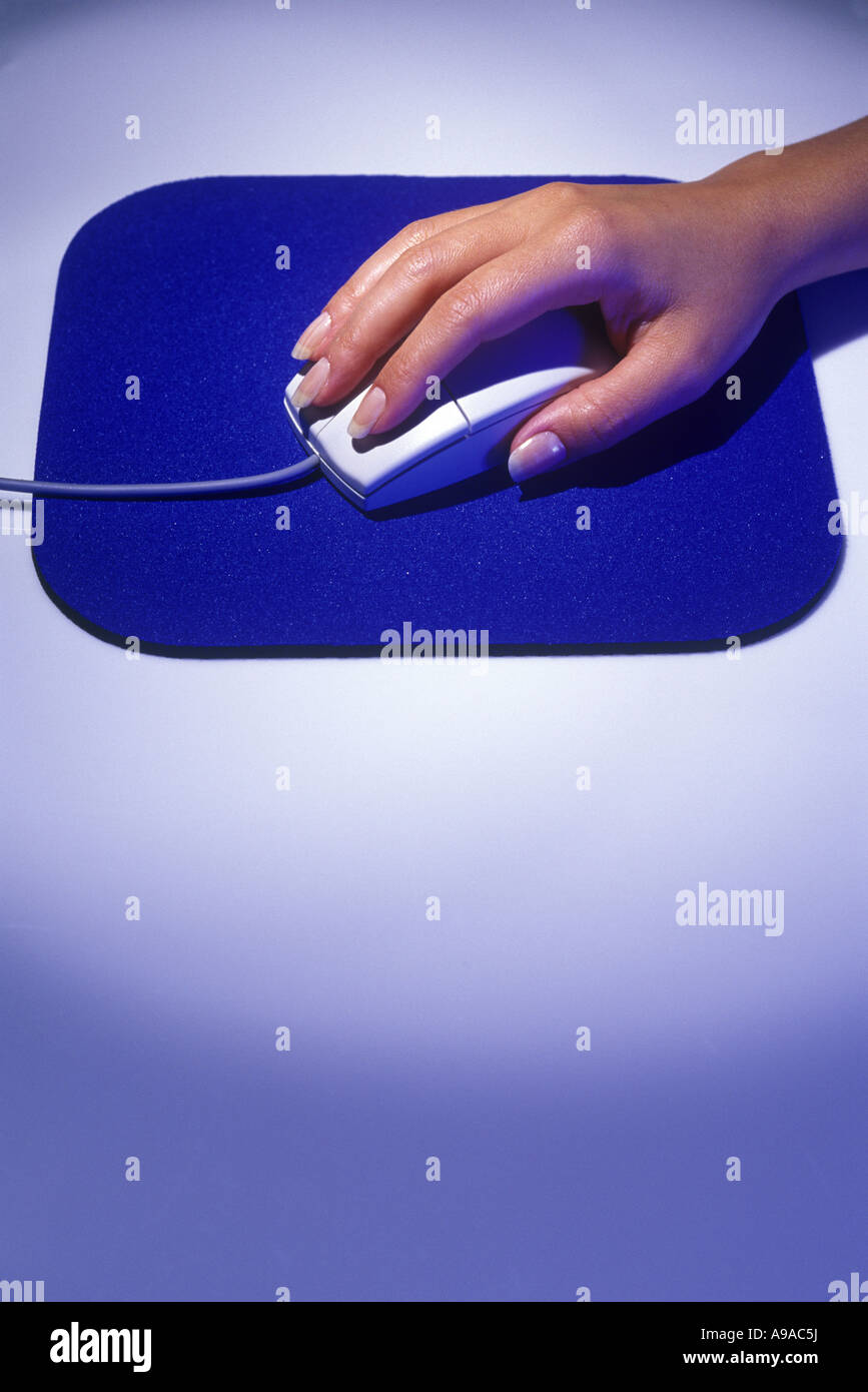 WOMANS HAND ON PERSONAL COMPUTER MOUSE AND BLUE MOUSE PAD Stock Photo ...