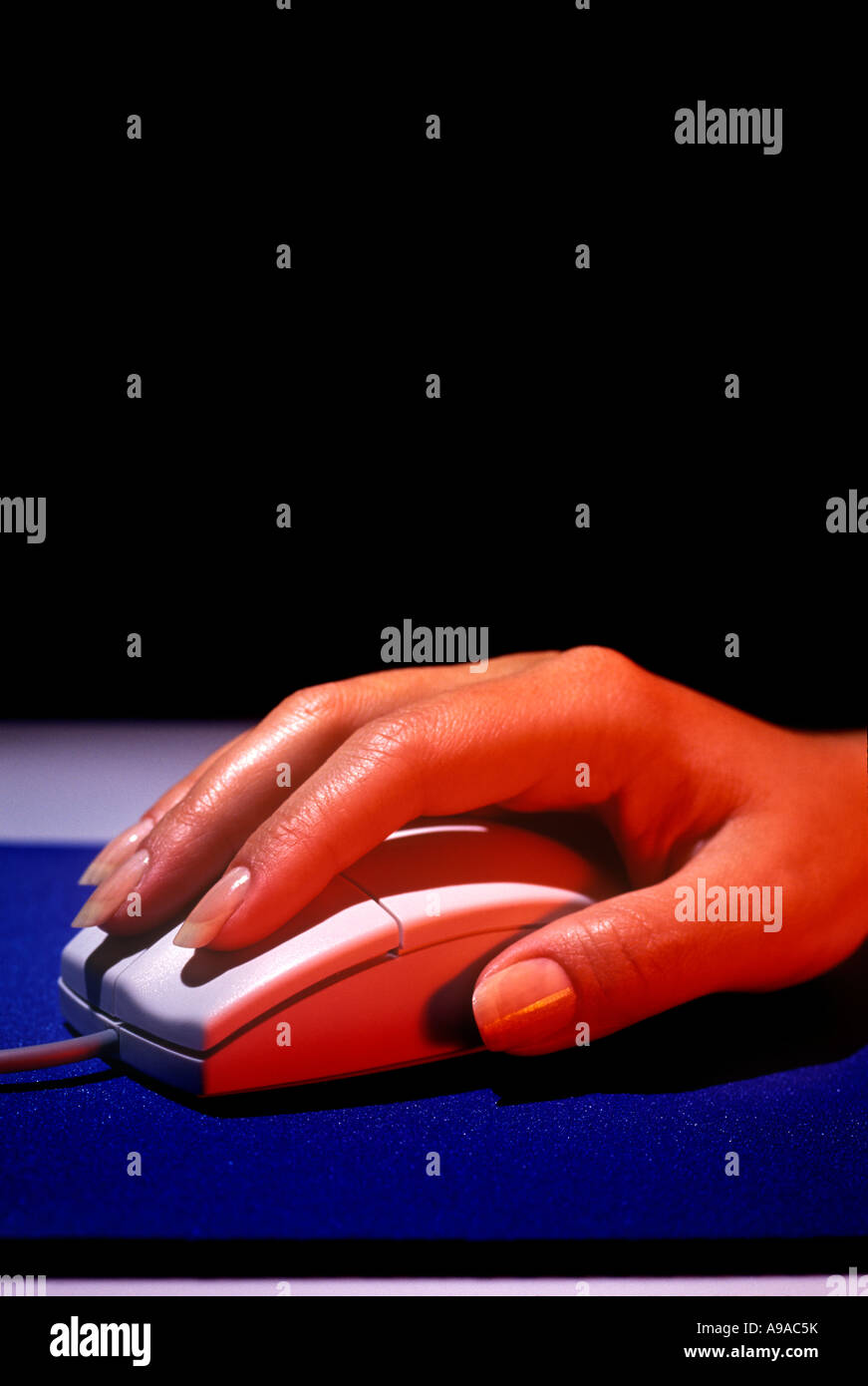 WOMANS HAND ON PERSONAL COMPUTER MOUSE AND BLUE MOUSE PAD Stock Photo ...