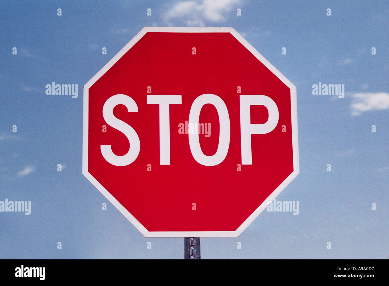 Octagonal stop sign with blue sky background Stock Photo - Alamy