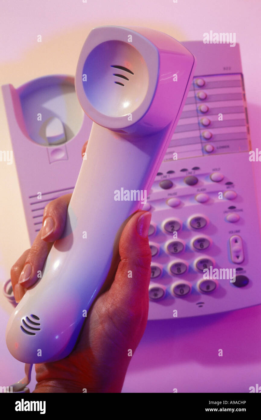 WOMANS HAND HOLDING UP HANDSET OF TELEPHONE Stock Photo - Alamy