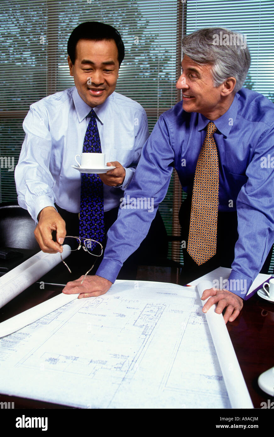 OFFICE WORKERS WITH CONSTRUCTION PLANS Stock Photo - Alamy