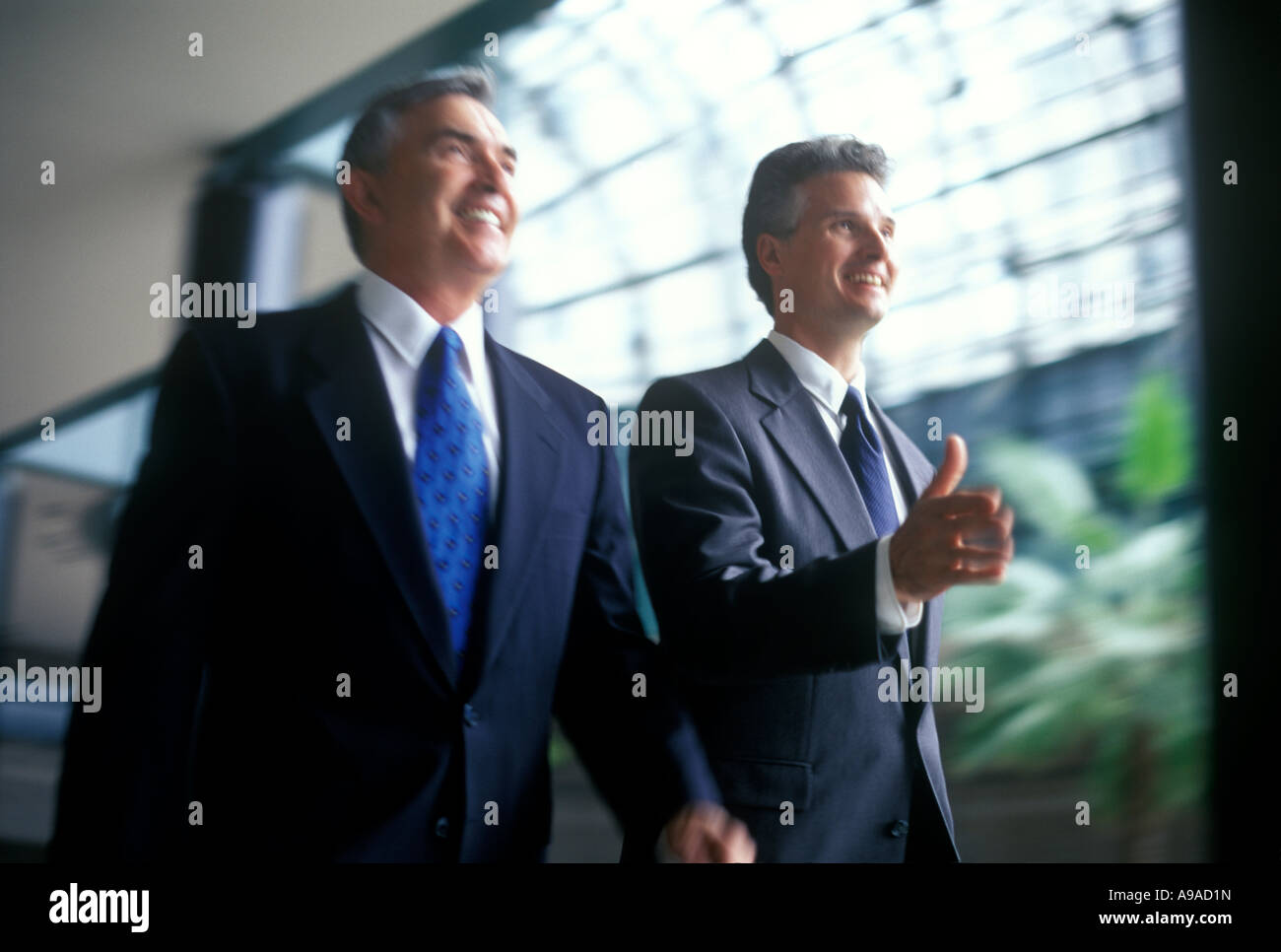 OFFICE WORKERS WALKING TOWARDS HANDSHAKE GREETING Stock Photo - Alamy