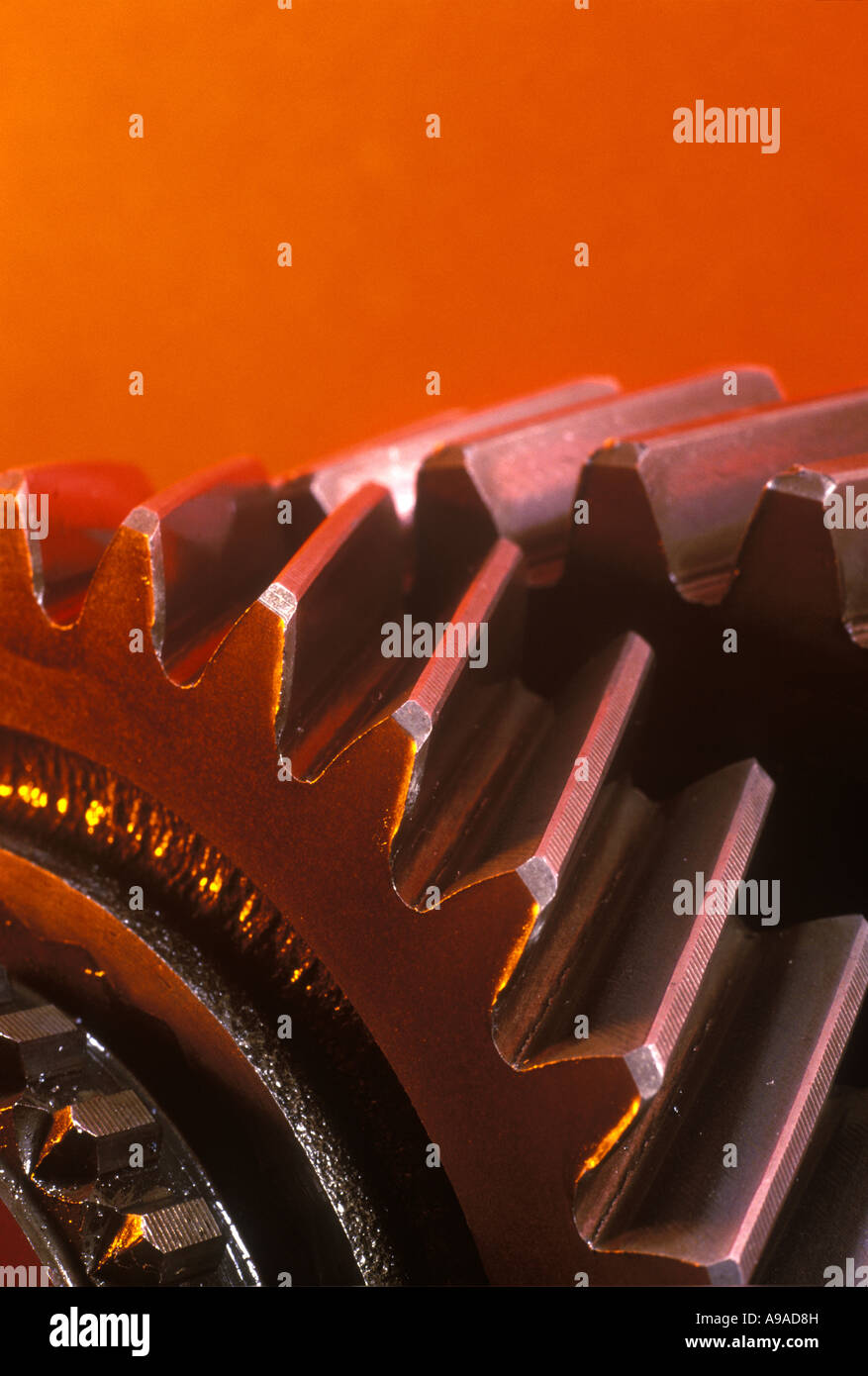 TWO METAL GEARS ON PLAIN ORANGE BACKGROUND Stock Photo - Alamy