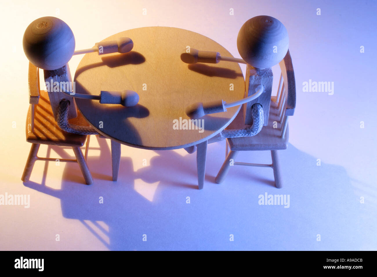 Figures at Table Stock Photo - Alamy