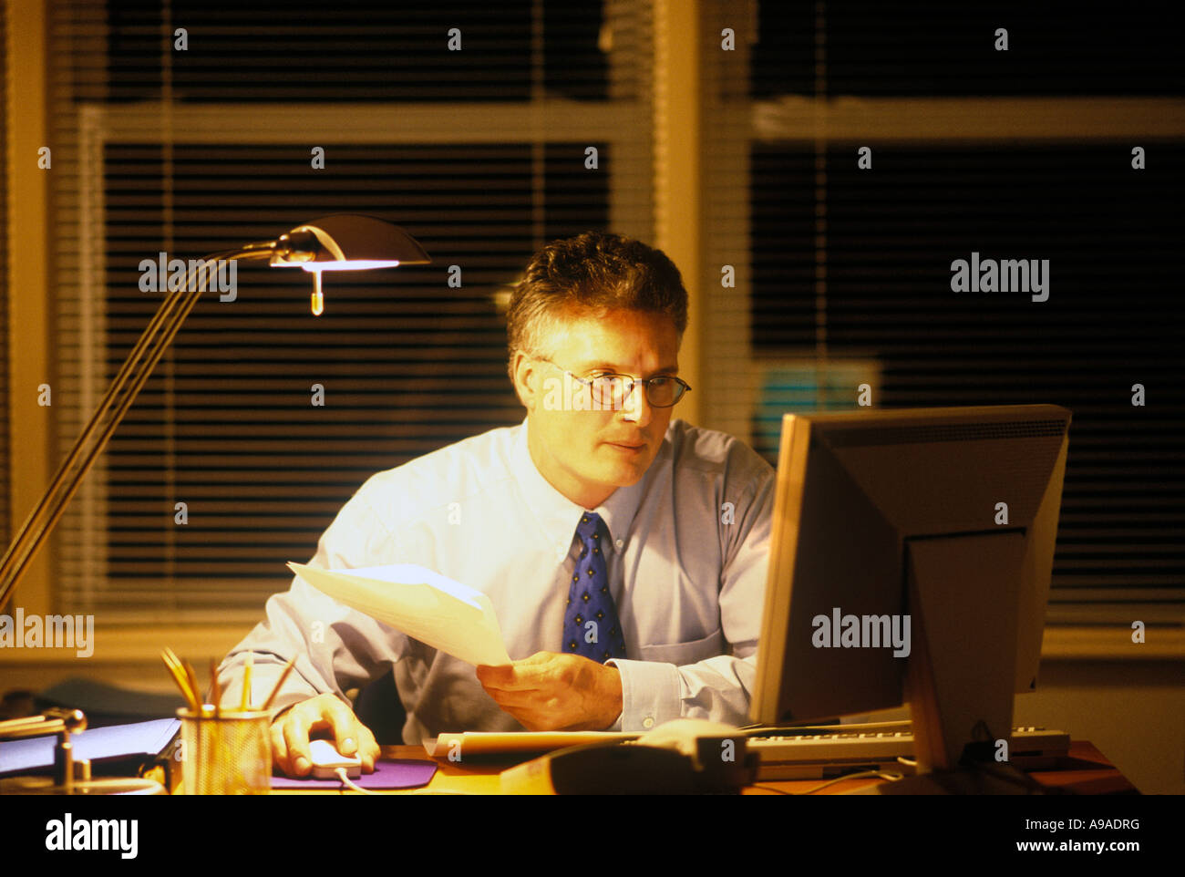 OFFICE WORKER WORKING LATE Stock Photo - Alamy