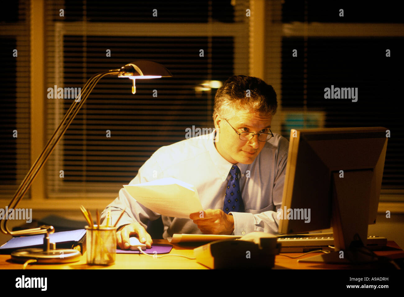 OFFICE WORKER WORKING LATE Stock Photo - Alamy