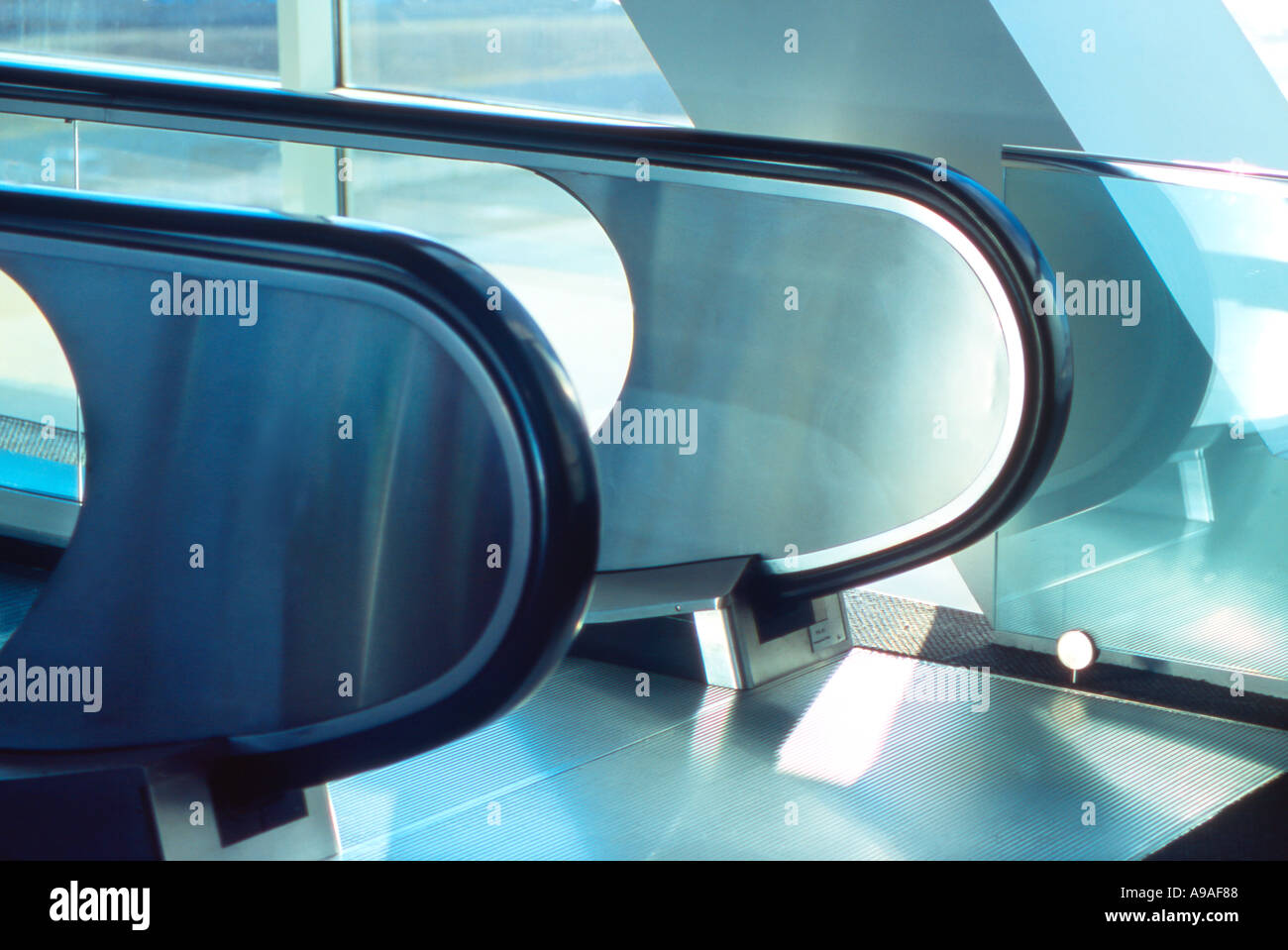 Graphic handrails on escalator in airport Stock Photo - Alamy