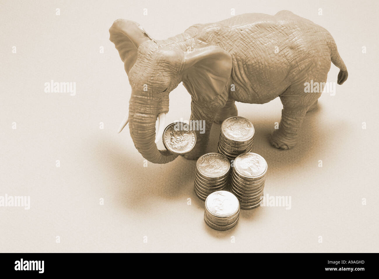 Toy Elephant and Coins Stock Photo - Alamy