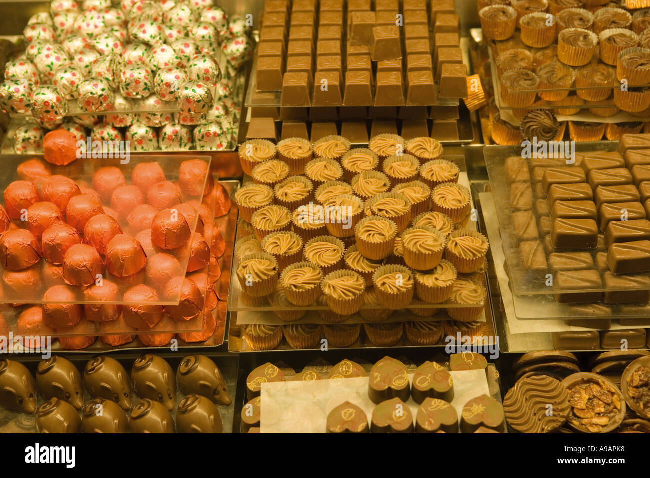 Chocolates on display in shop window Stock Photo - Alamy