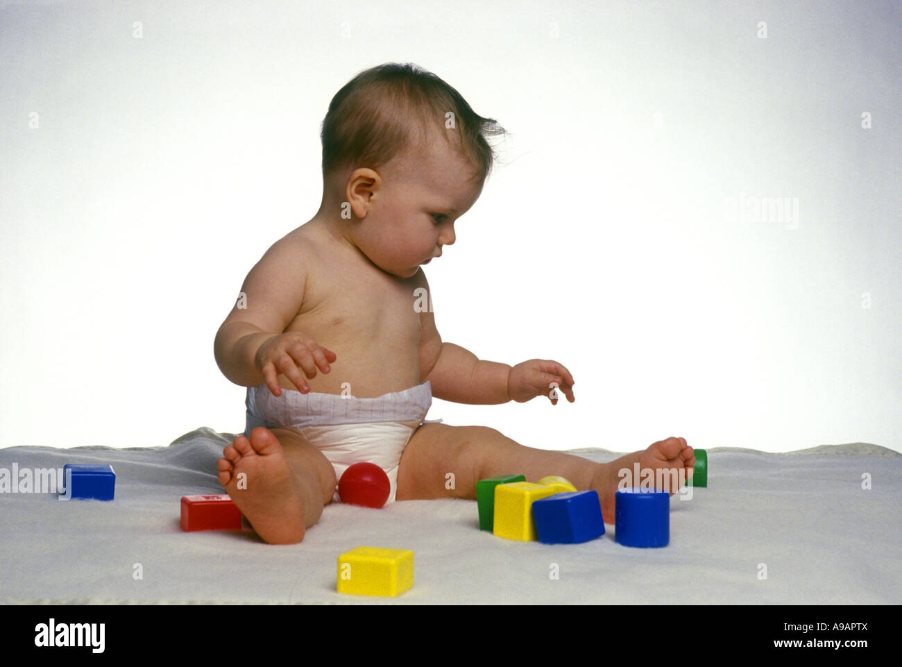 Baby girl playing colored blocks hi-res stock photography and images ...