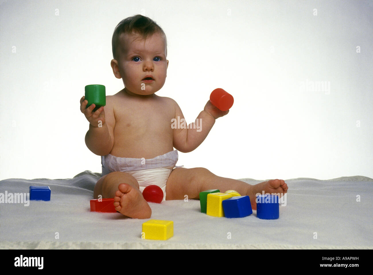 Baby girl playing colored blocks hi-res stock photography and images ...