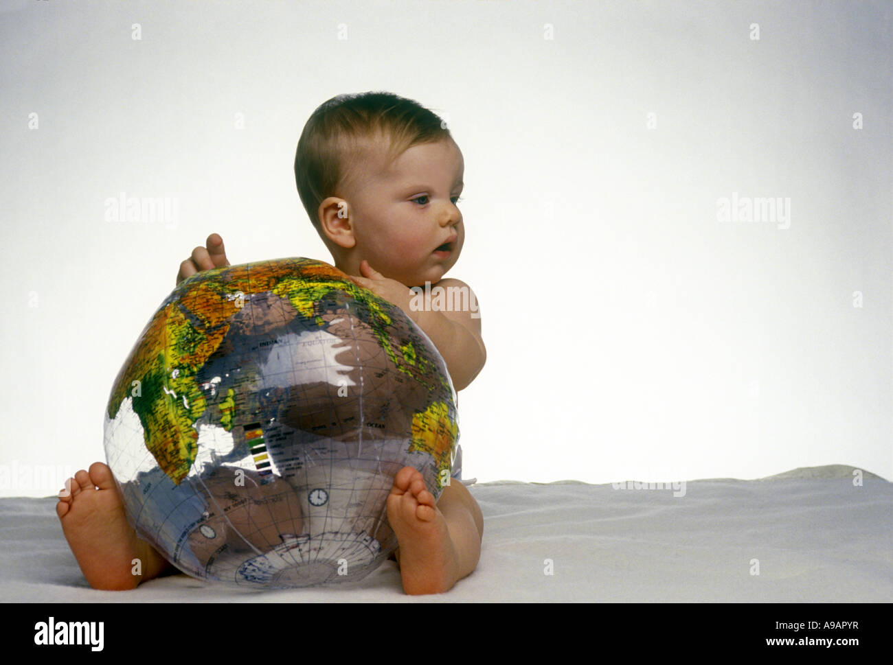 INFANT BABY PLAYING WITH PLASTIC PLANET EARTH GLOBE Stock Photo - Alamy
