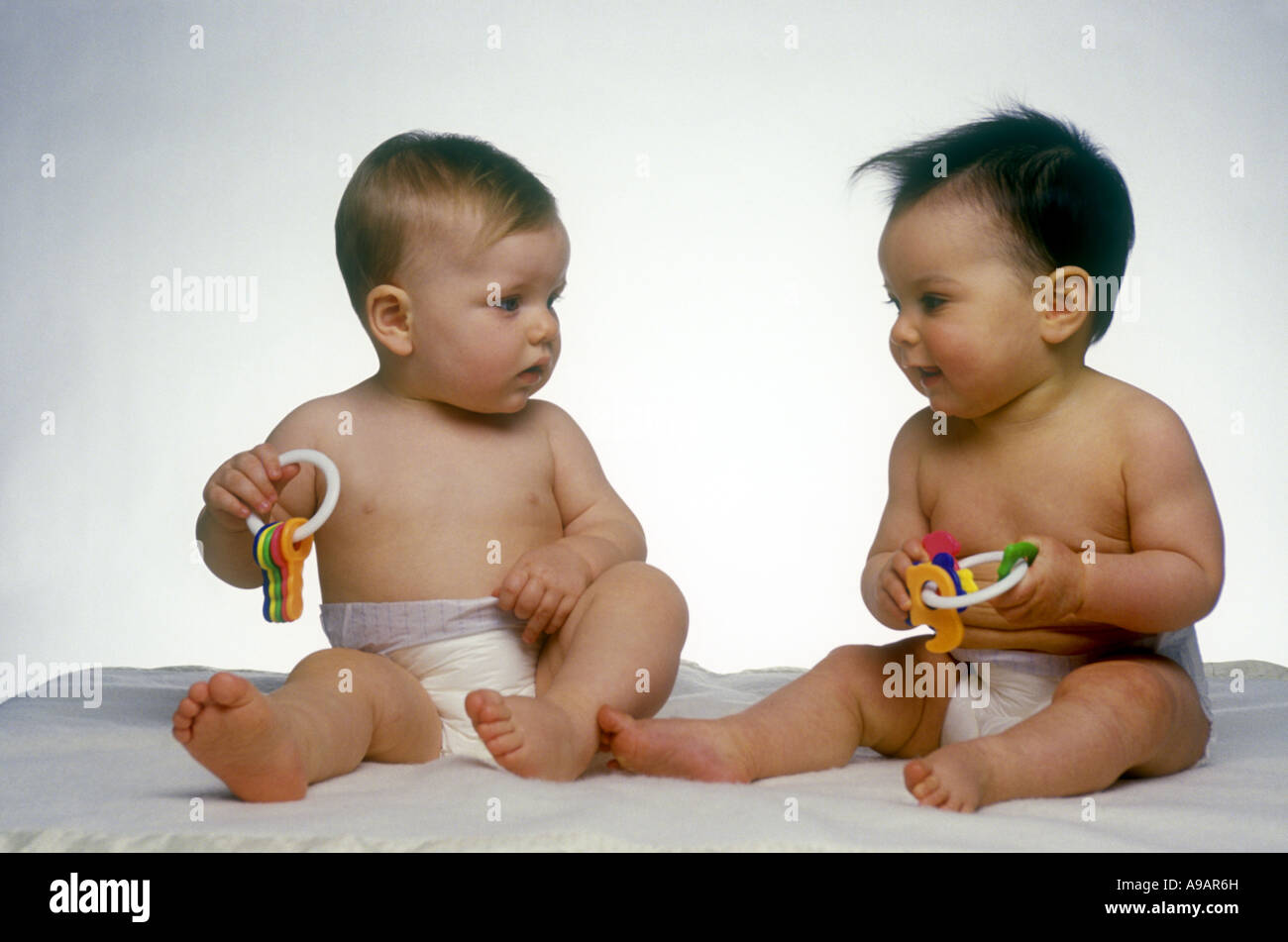 INFANT BABIES PLAYING WITH COLORED PLASTIC TOY KEYS Stock Photo - Alamy