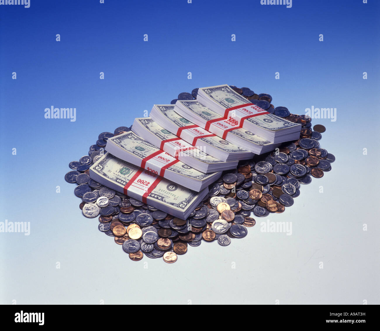 BUNDLES OF AMERICAN CURRENCY NOTES ON PILE OF US COINS Stock Photo - Alamy