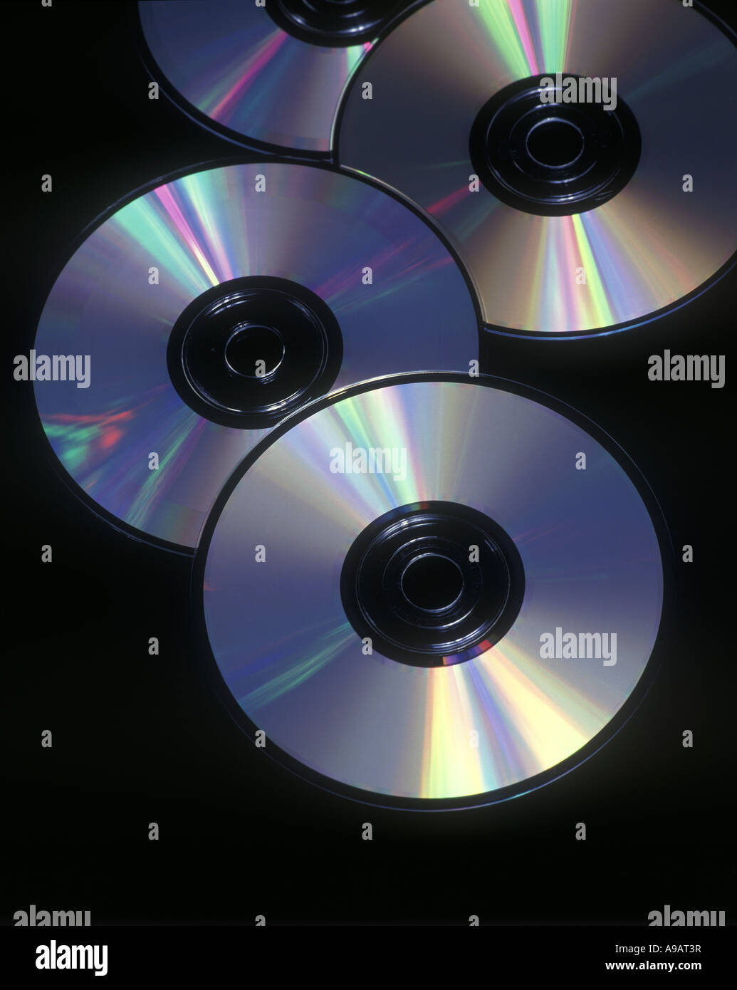 CLOSE UP ROW OF COMPACT CD ROM DISCS ON BLACK BACKGROUND Stock Photo ...