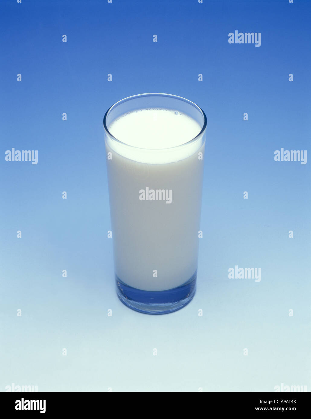 GLASS OF MILK ON BLUE BACKGROUND Stock Photo - Alamy