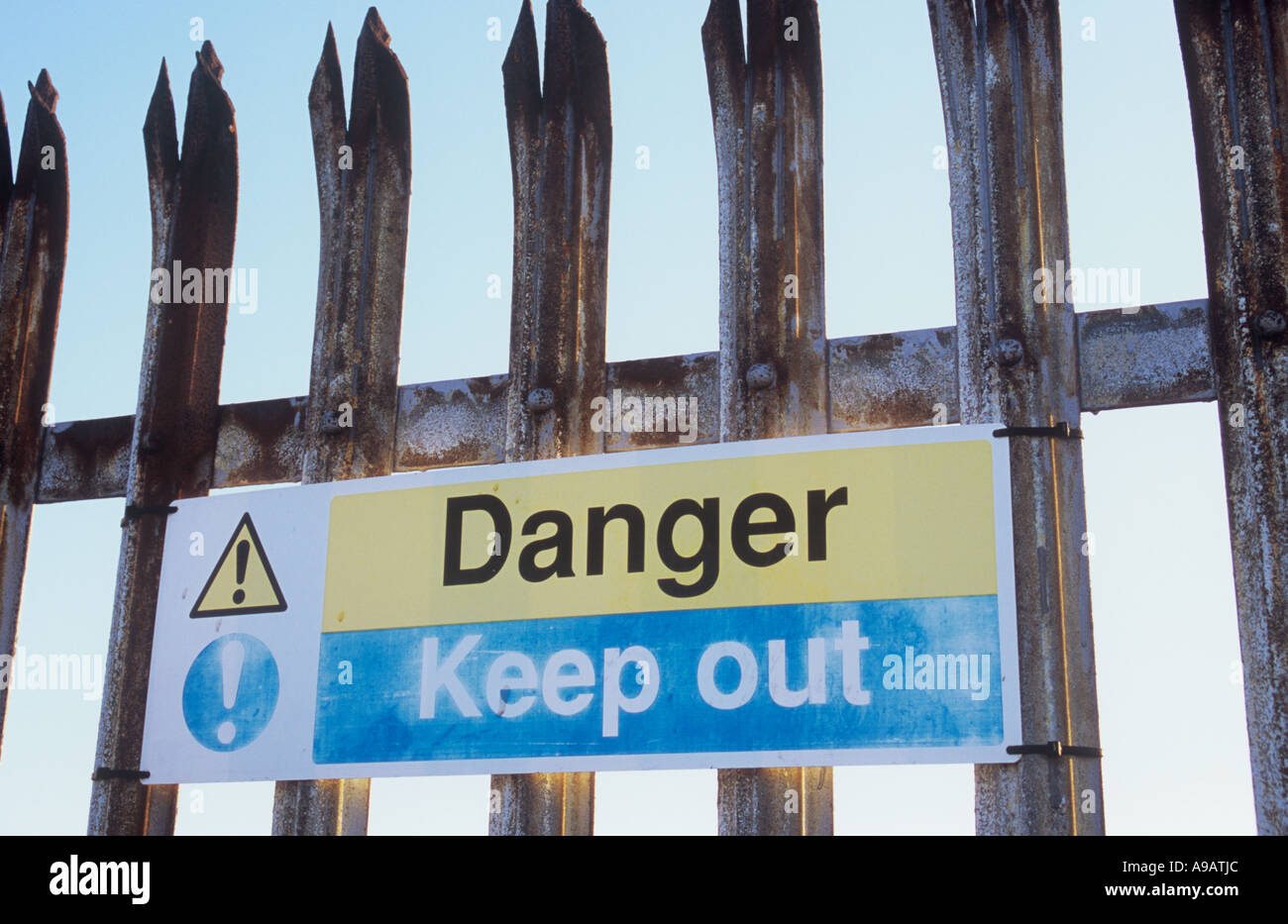 Close up of weathered sign fixed to a rusting metal pronged security ...
