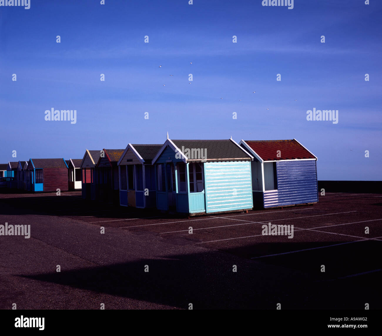 Beach huts moved to a car park for the winter to protect them from the ...
